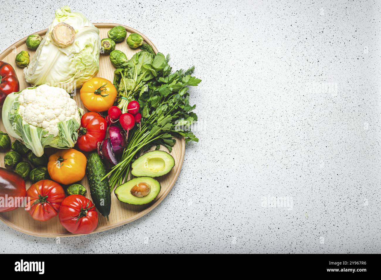 Rustic wooden tray with selection of fresh vegetables and greenery on ...