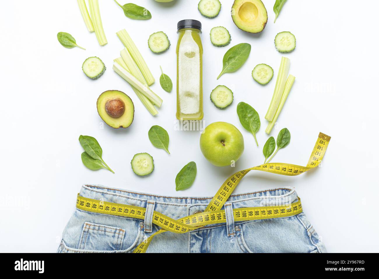 Green fruit, vegetables, smoothie falling into jeans and yellow ...