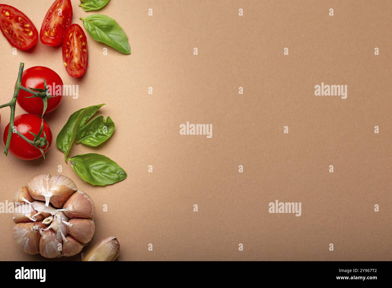 Food cooking border with cherry tomatoes, fresh green basil and garlic ...
