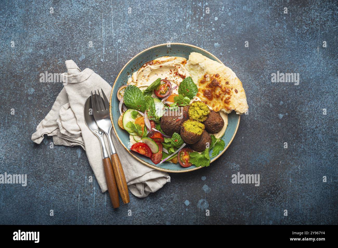 Middle Eastern Arab meal with fried falafel, hummus, vegetables salad ...