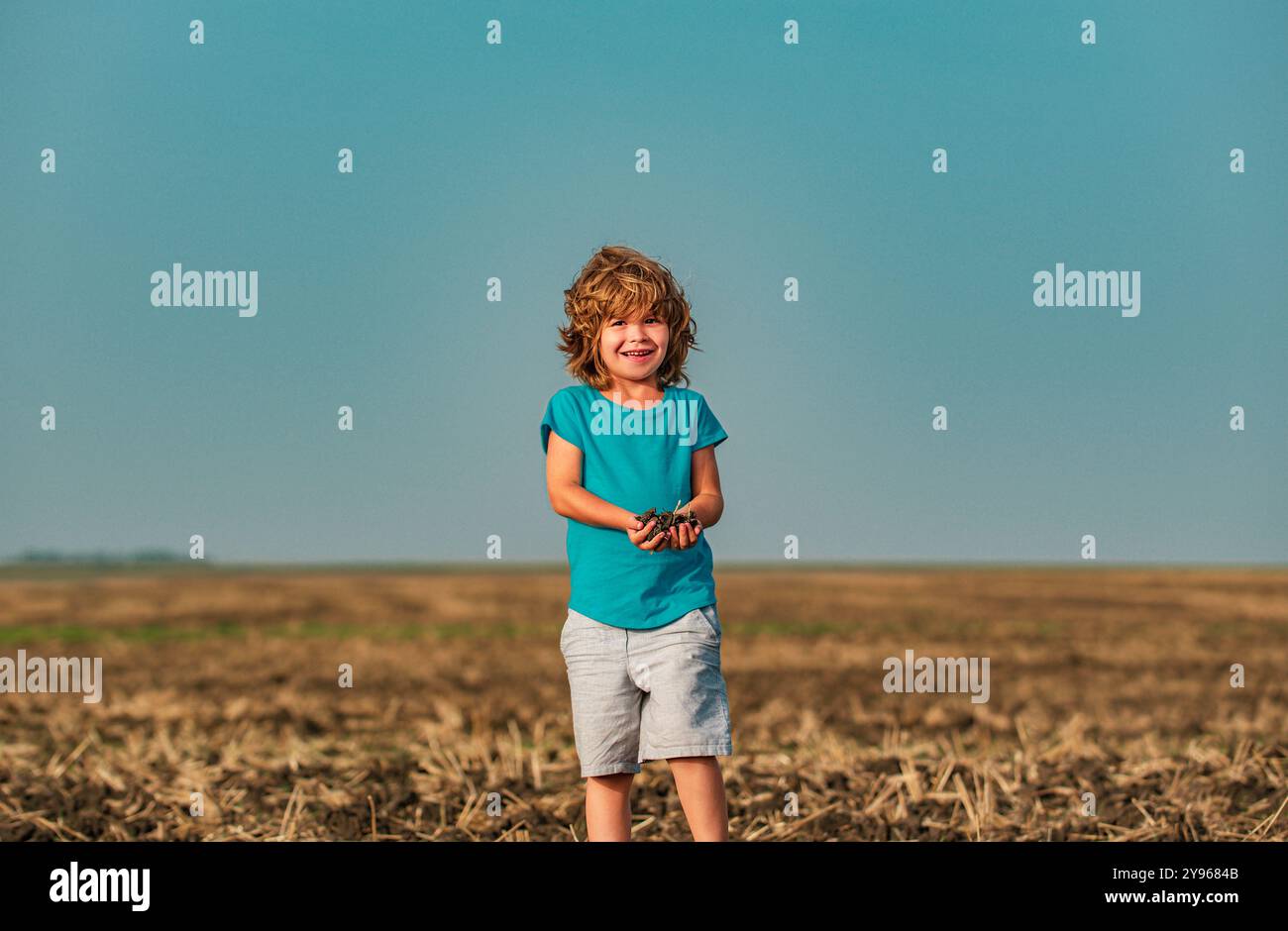 Cute child on the black soil background. Soils and fertilizers Stock ...