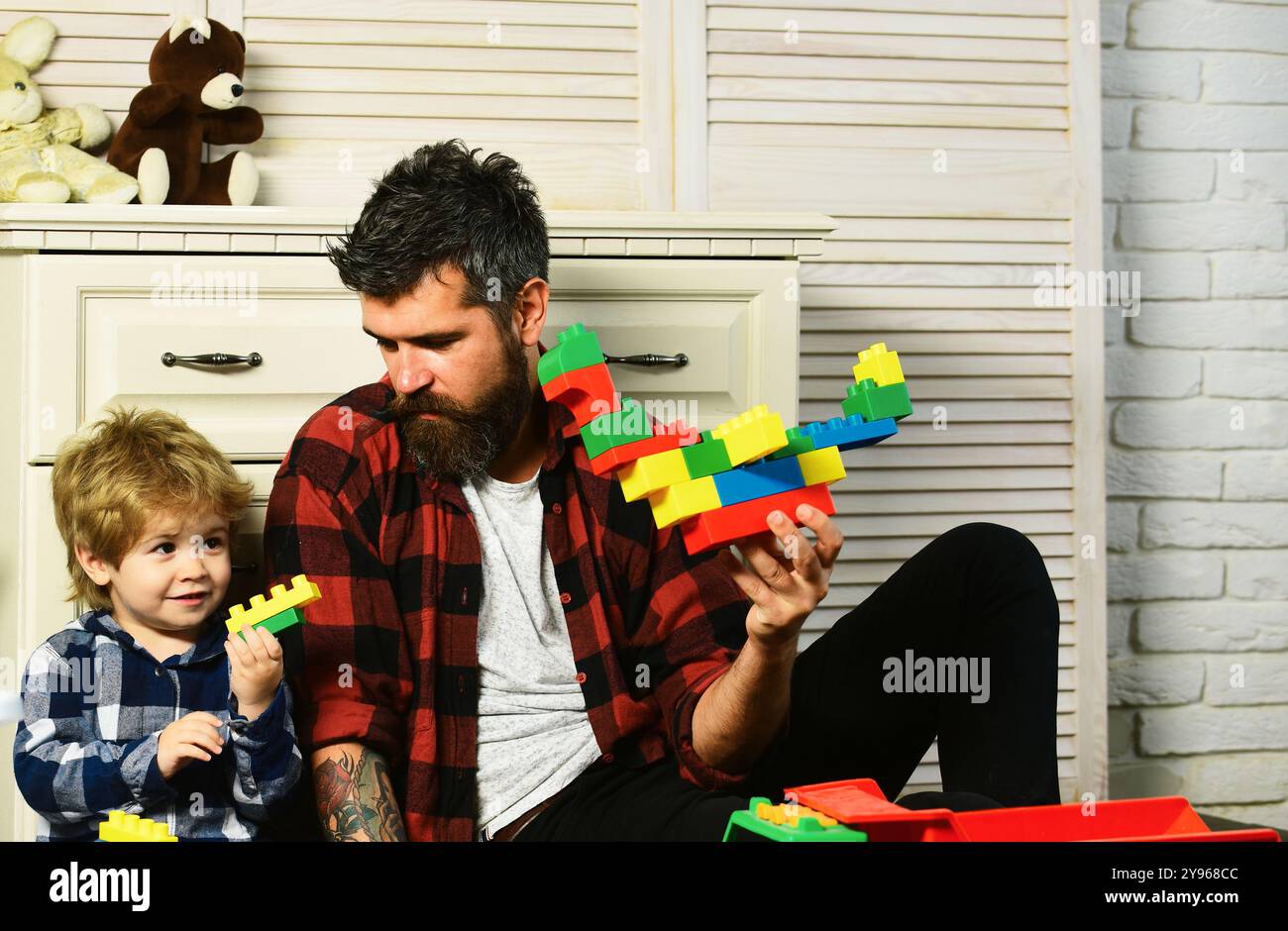 Loving dad and little boy child have fun play build construct with ...