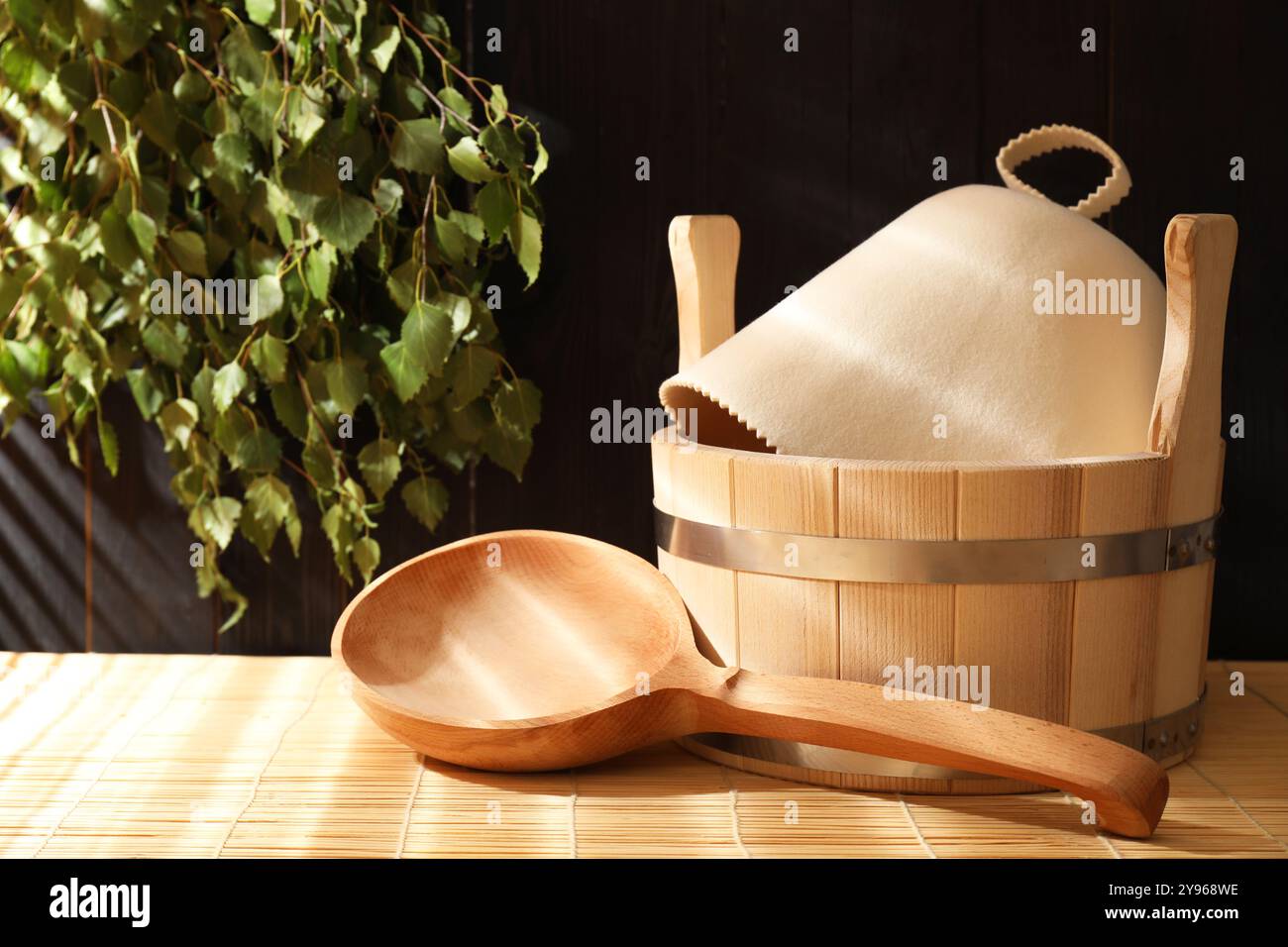 Sauna equipment. Bucket, felt wool hat and ladle on bamboo bench Stock ...