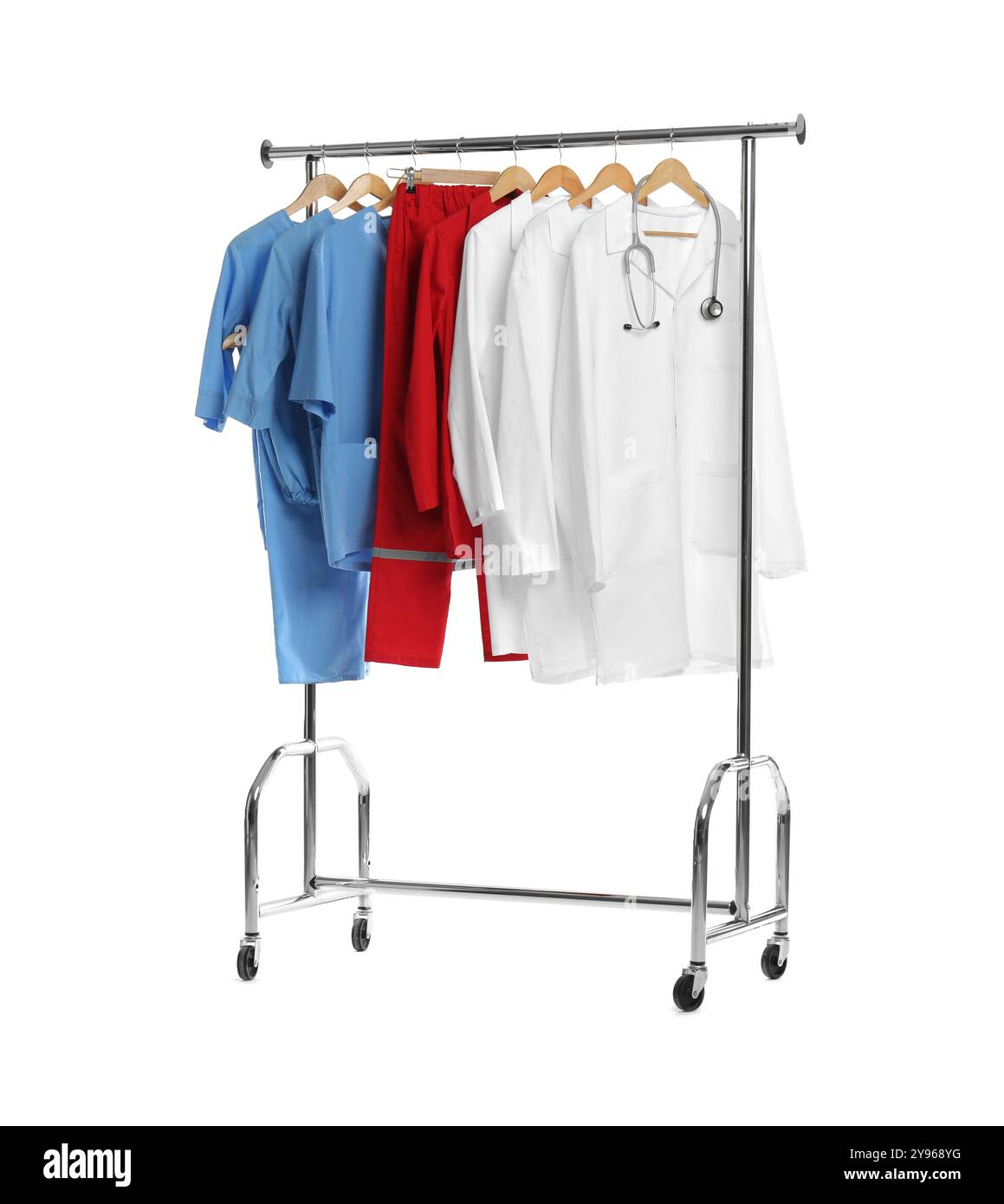 Different medical workers' uniforms and stethoscope on clothing rack ...