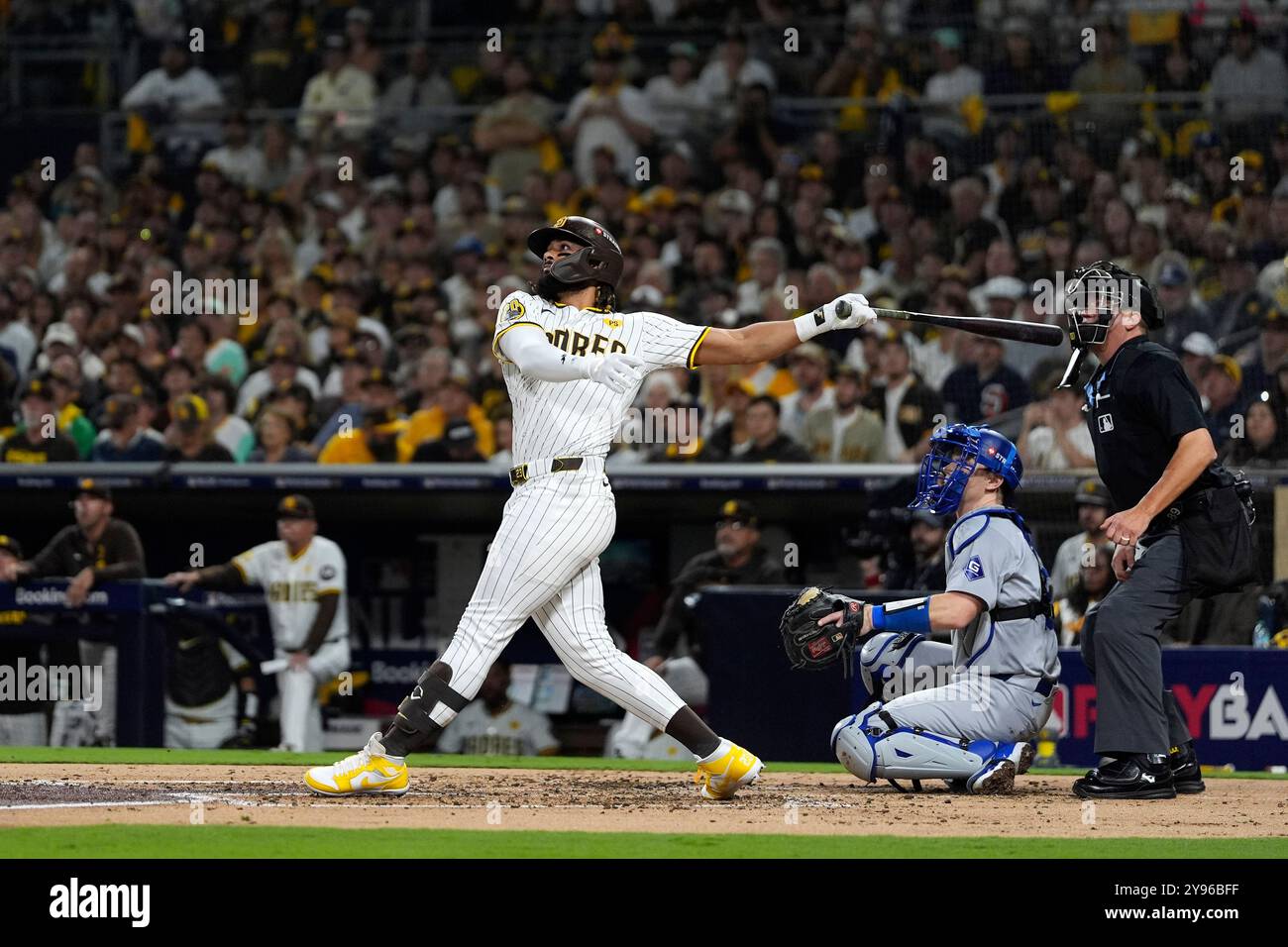 San Diego Padres' Fernando Tatis Jr., left, follows through on his two ...