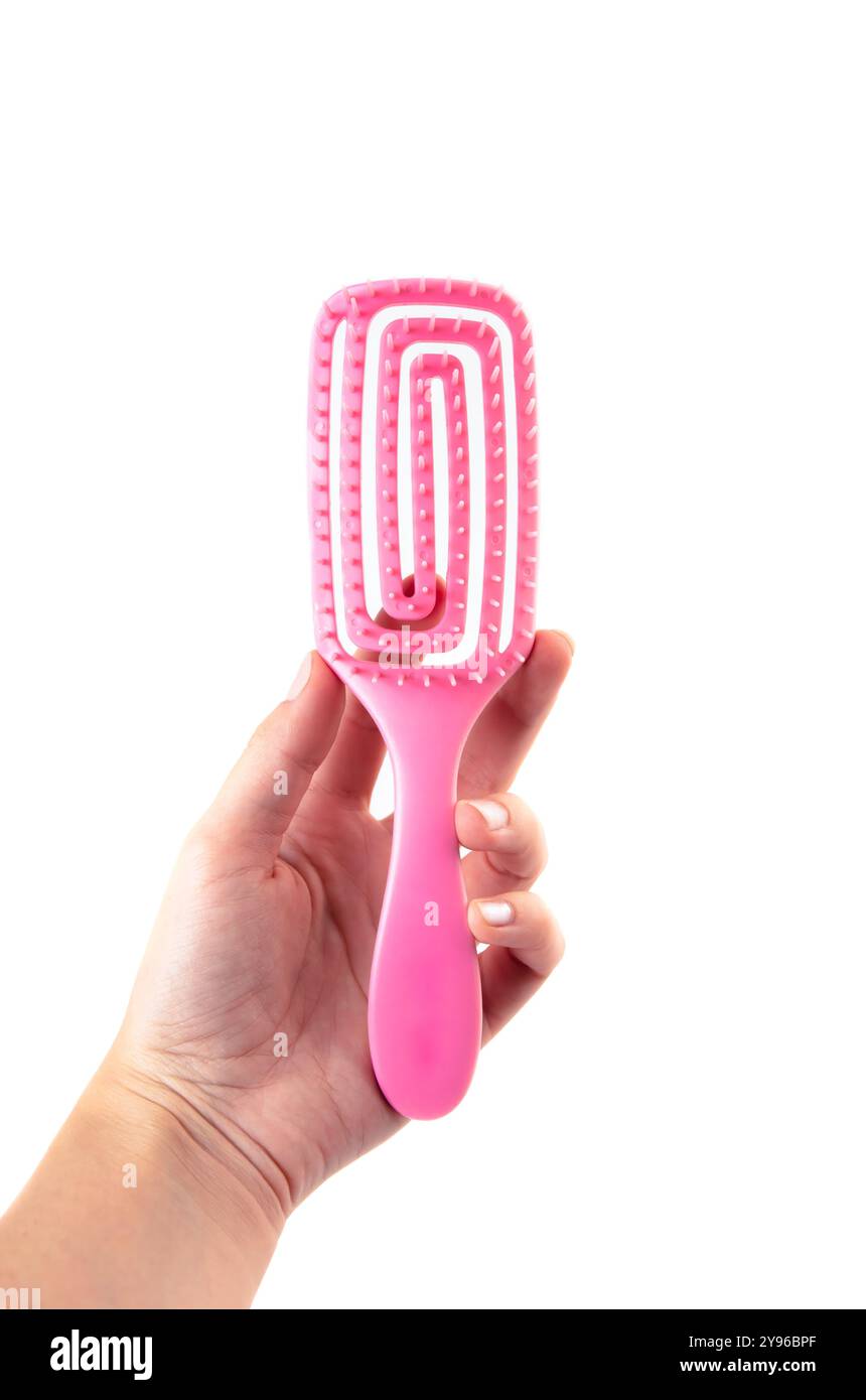 Female hand holding aroma hair comb for massage of head isolated on ...