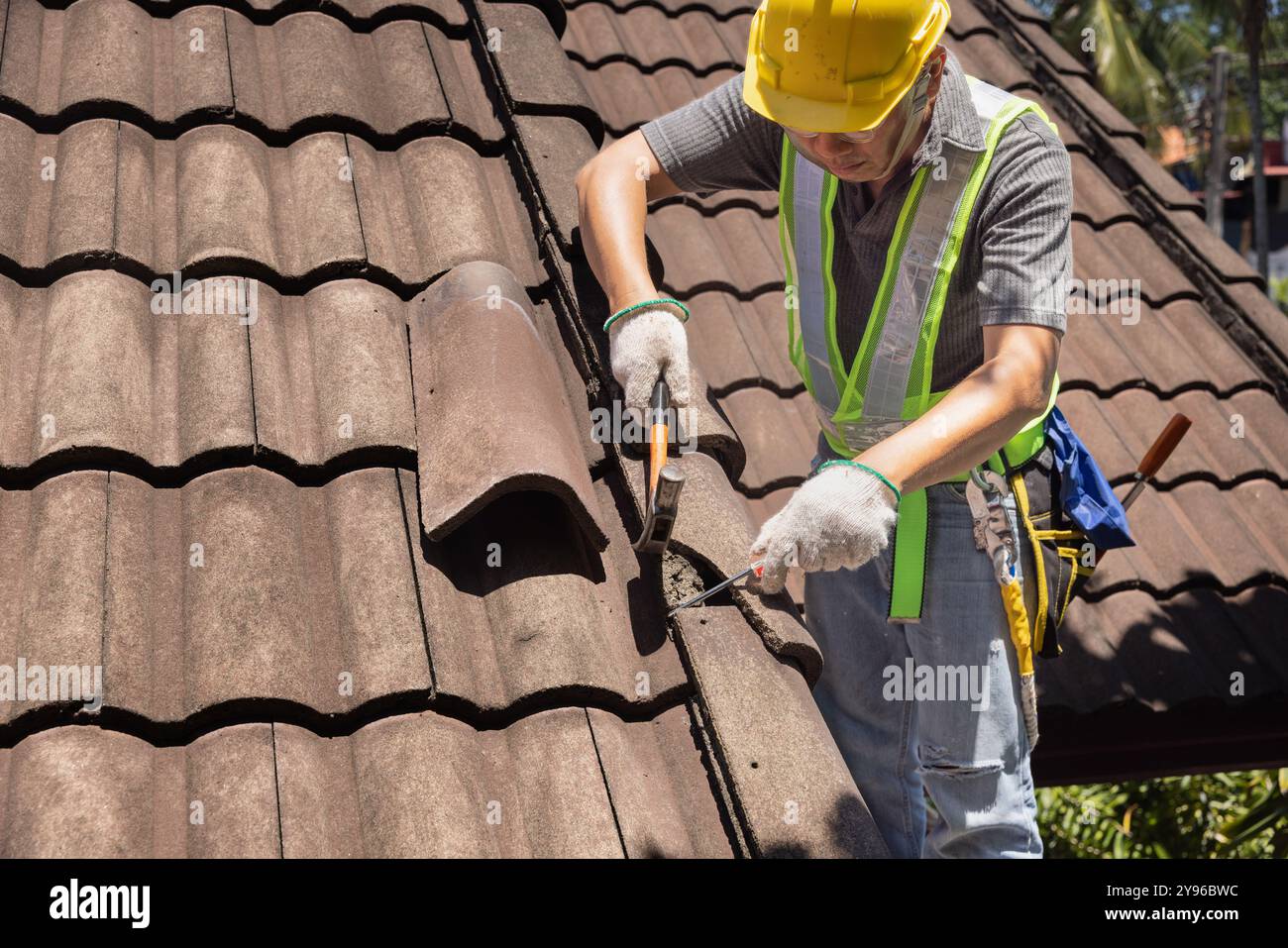Worker man replace tile of the old roof. Repair roof concept Stock ...