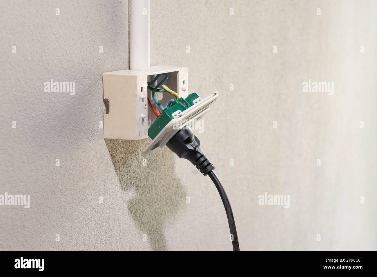Dangerous broken electrical socket falling out of wall Stock Photo - Alamy