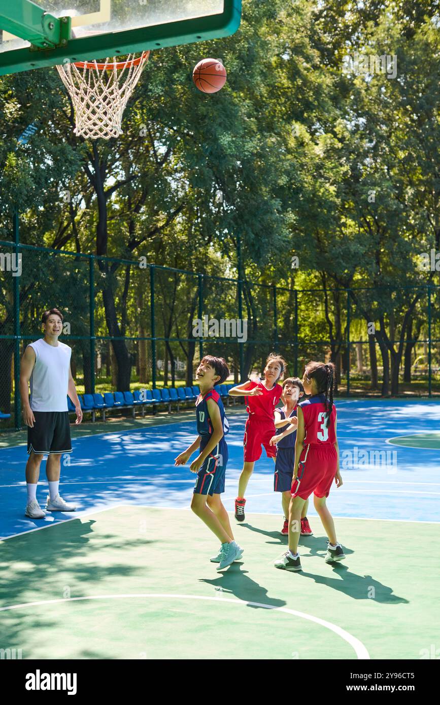 Kids Playing Basketball on Basketball Court Stock Photo - Alamy