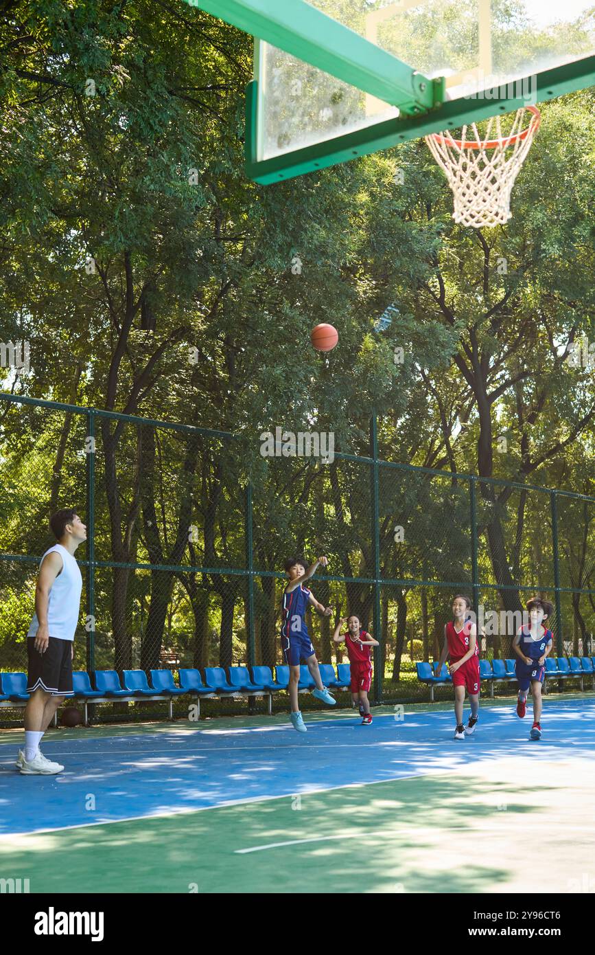 Kids Playing Basketball on Basketball Court Stock Photo - Alamy