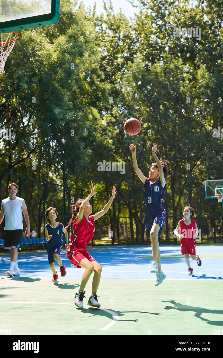 Kids Playing Basketball on Basketball Court Stock Photo - Alamy