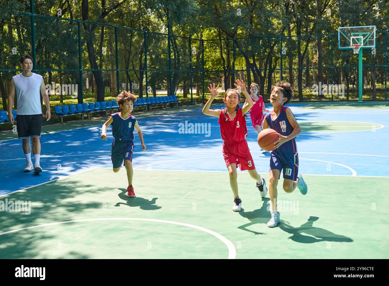 Chinese Kids Playing Basketball on Basketball Court Stock Photo - Alamy