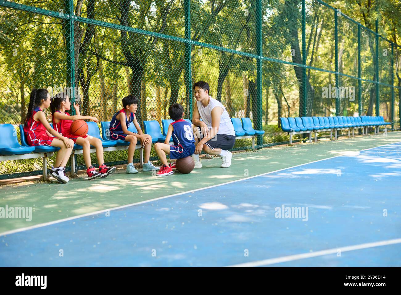 Chinese Coach and Kids in Discussion Stock Photo - Alamy