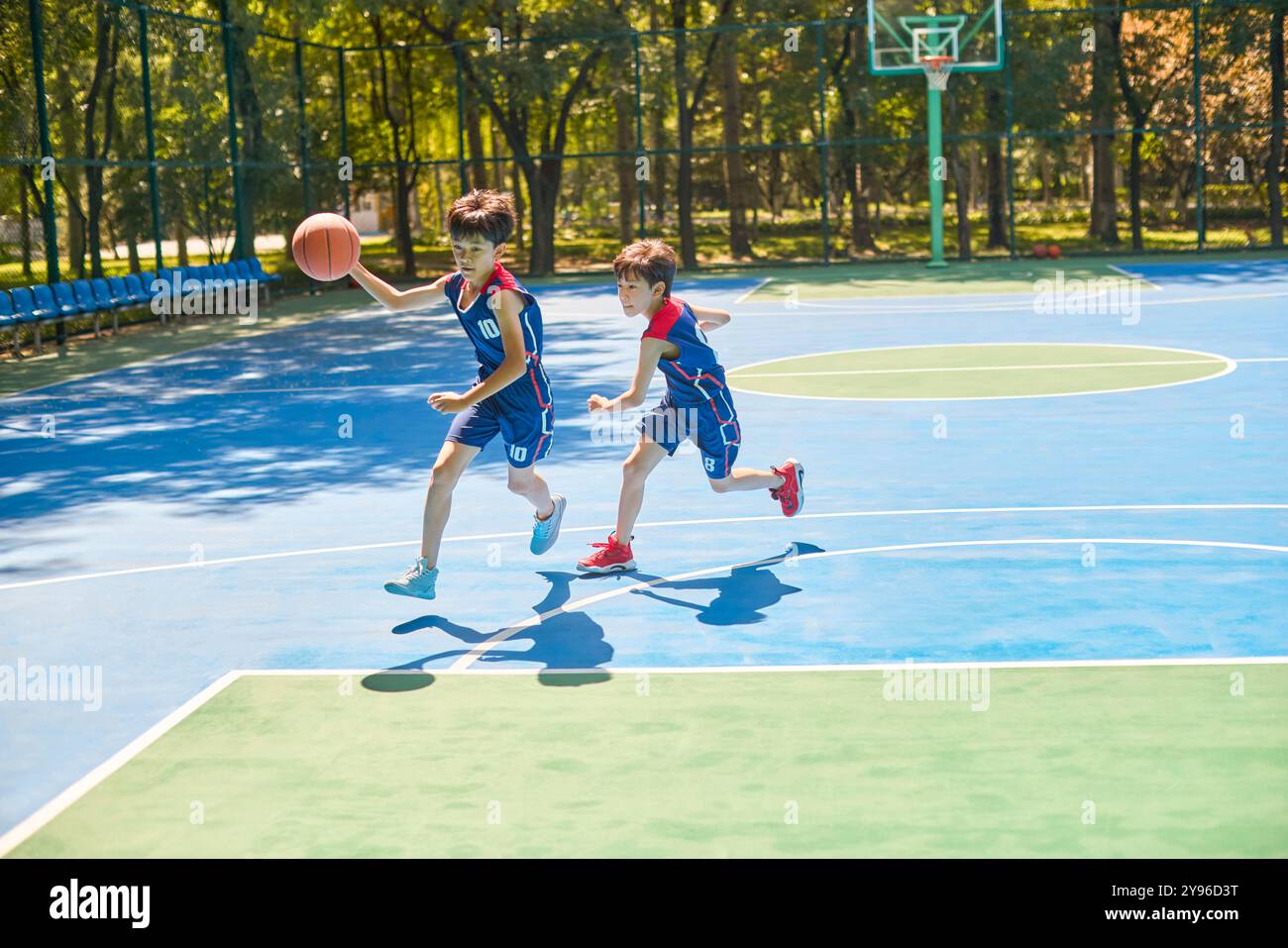 Kids Playing Basketball on Basketball Court Stock Photo - Alamy