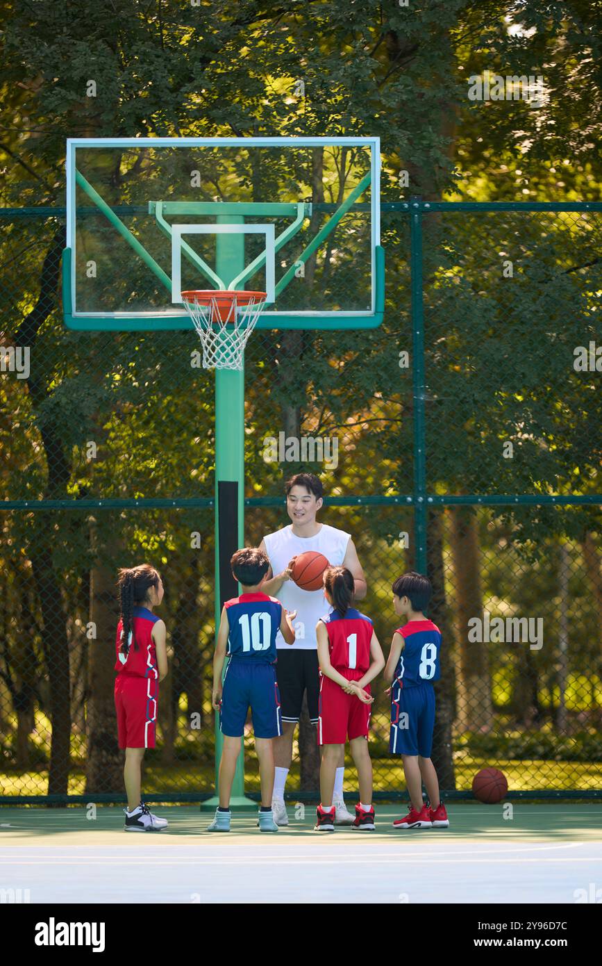 Coach and Kids in Basketball Training Class Stock Photo - Alamy