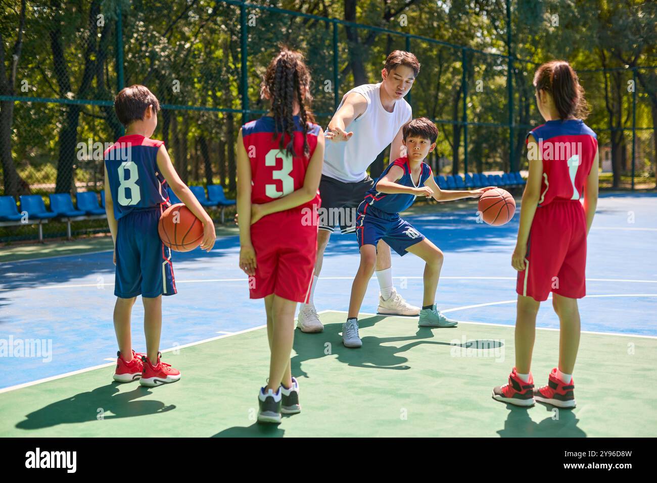 Coach and Kids in Basketball Training Class Stock Photo - Alamy