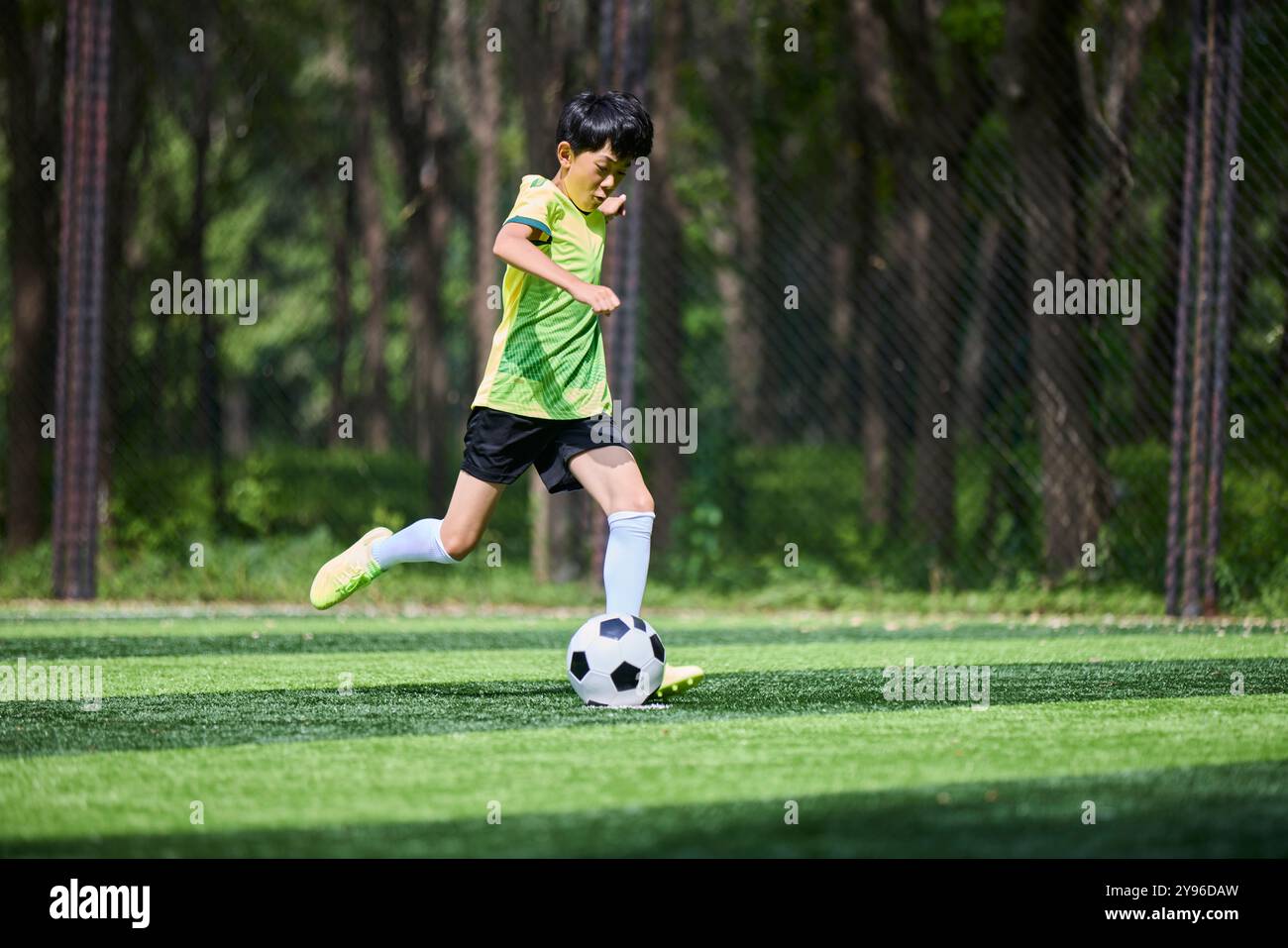 Indian boy kicking football hi-res stock photography and images - Alamy