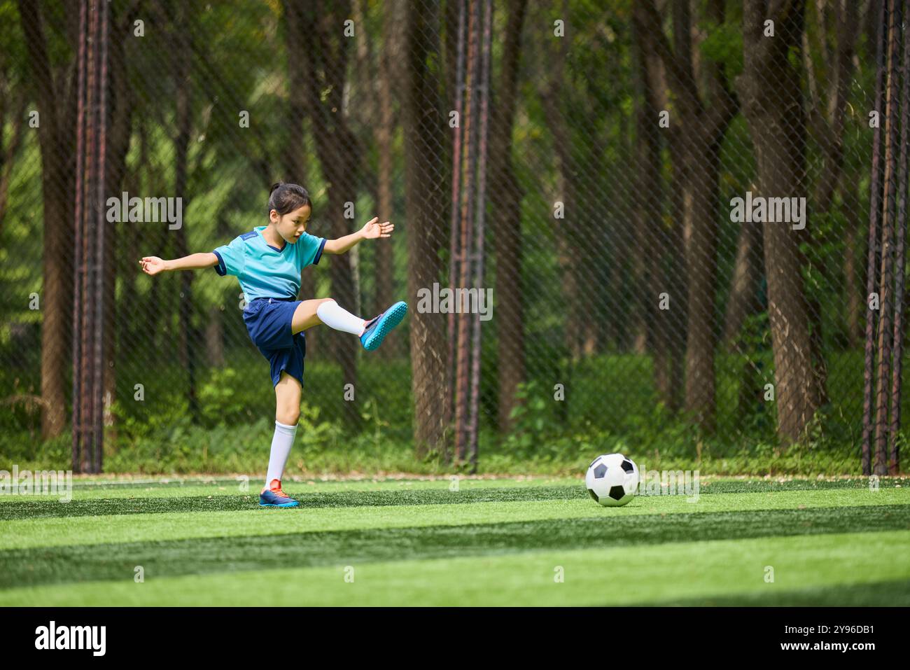 Girl Playing Football on Soccer Field Stock Photo - Alamy