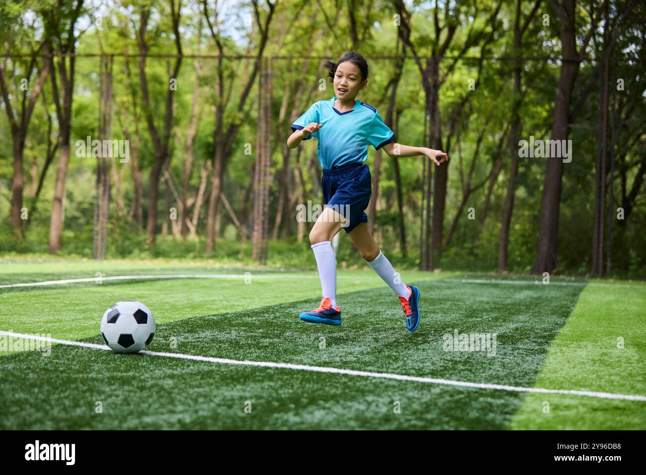Girl Playing Football on Soccer Field Stock Photo - Alamy
