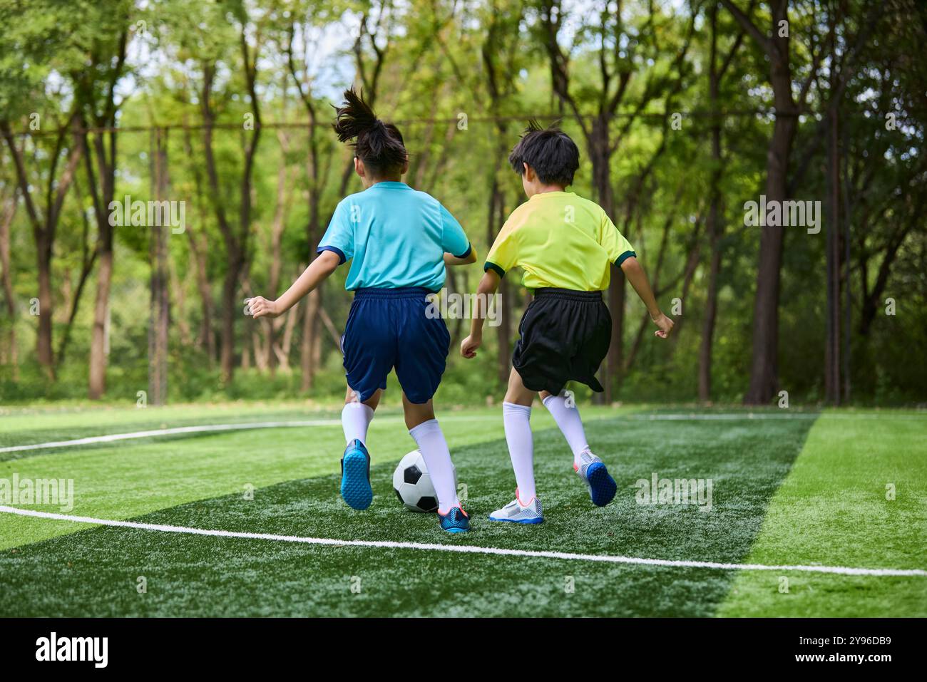 Kids Playing Football on Soccer Field Stock Photo - Alamy