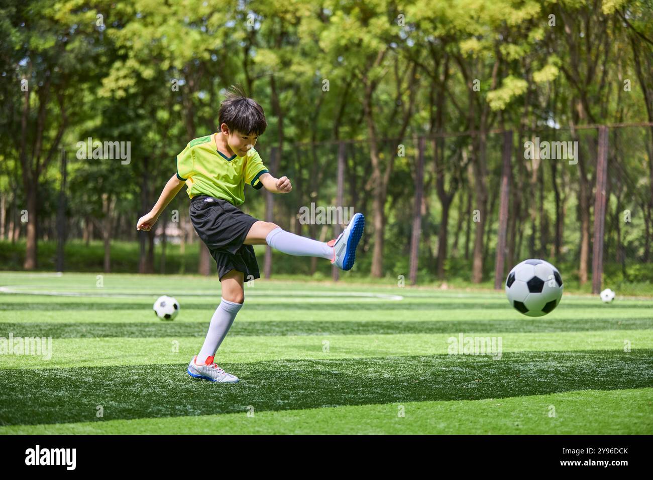 Indian boy kicking football hi-res stock photography and images - Alamy