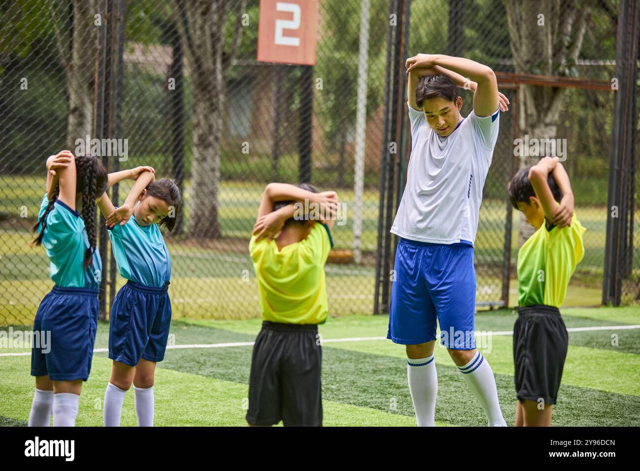 Coach and Kids in Football Training Class Stock Photo - Alamy