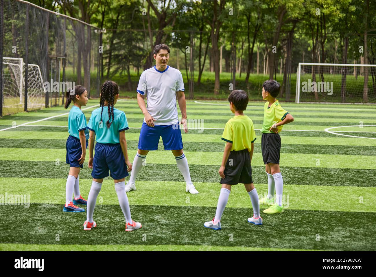 Coach and Kids in Football Training Class Stock Photo - Alamy