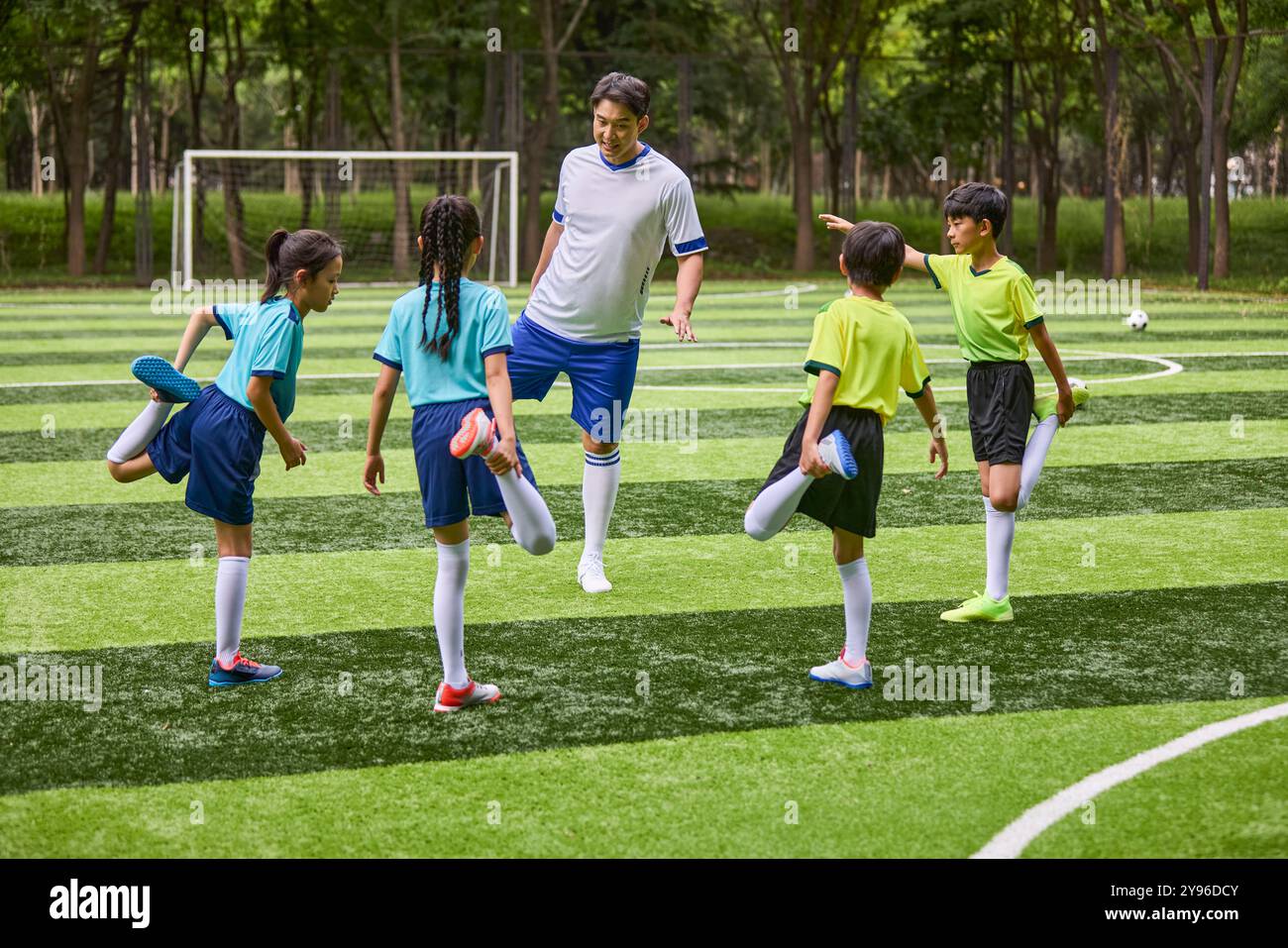 Coach and Kids in Football Training Class Stock Photo - Alamy