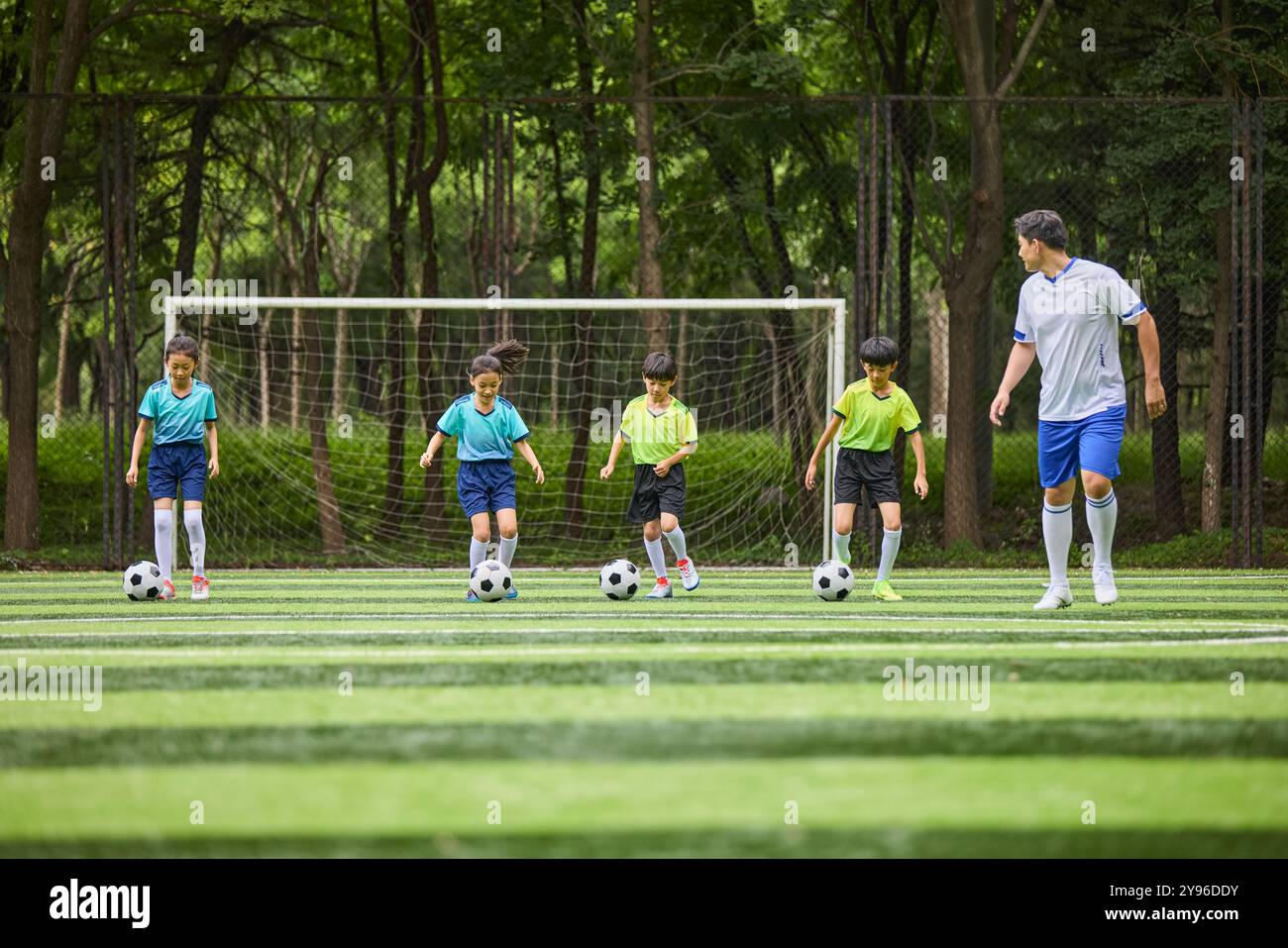 Coach and Kids in Football Training Class Stock Photo - Alamy