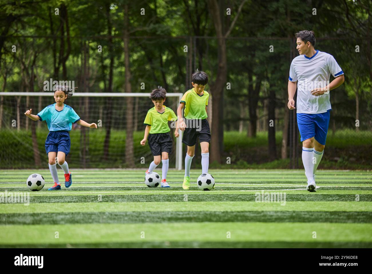 Coach and Kids in Football Training Class Stock Photo - Alamy
