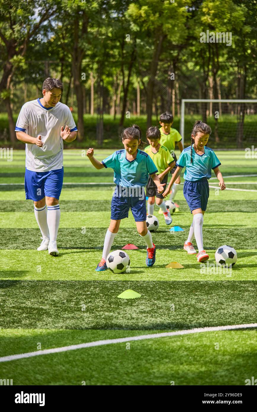Coach and Kids in Football Training Class Stock Photo - Alamy