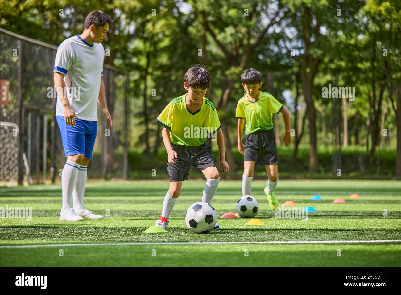 Coach and Kids in Football Training Class Stock Photo - Alamy
