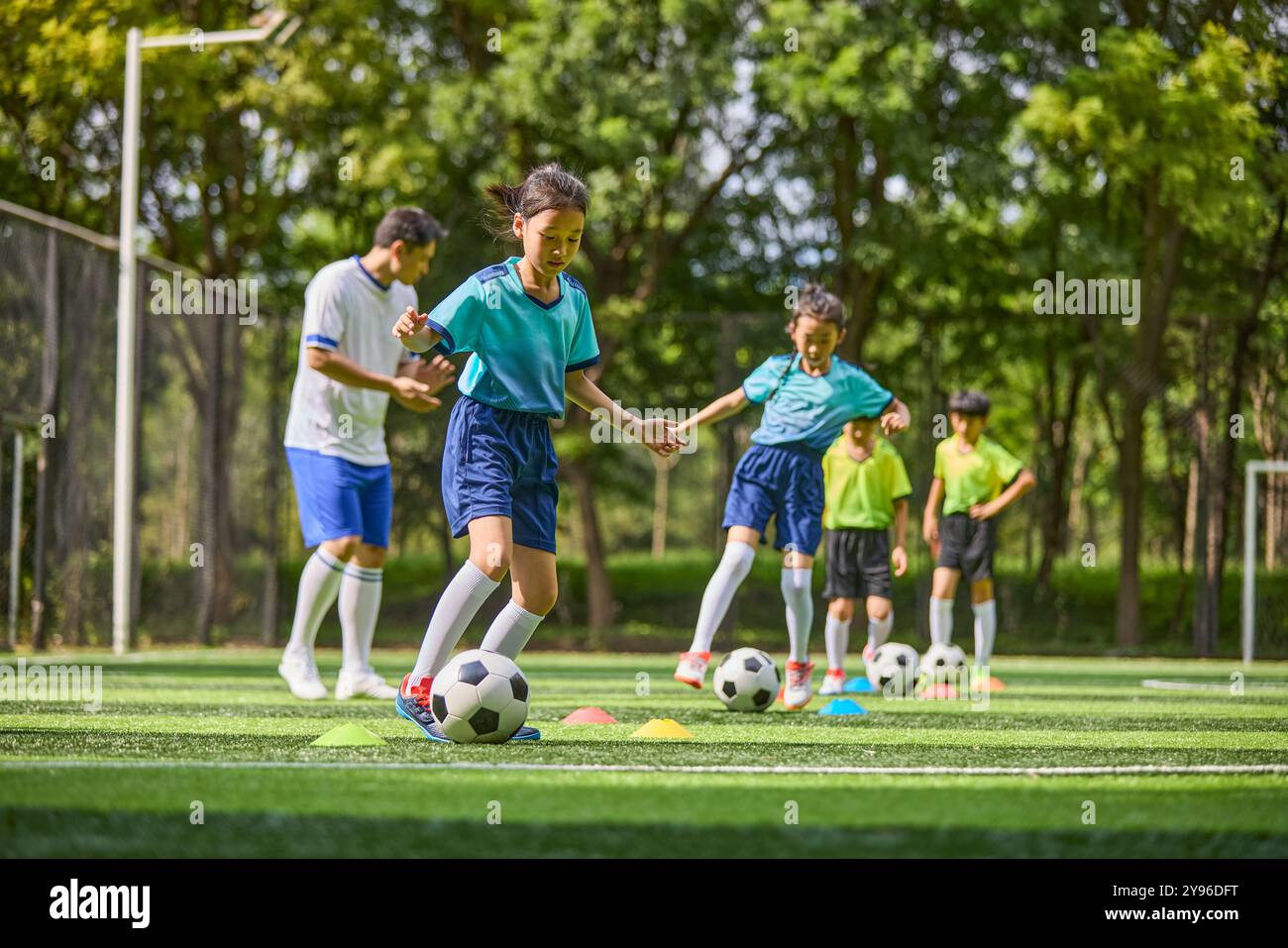 Coach and Kids in Football Training Class Stock Photo - Alamy