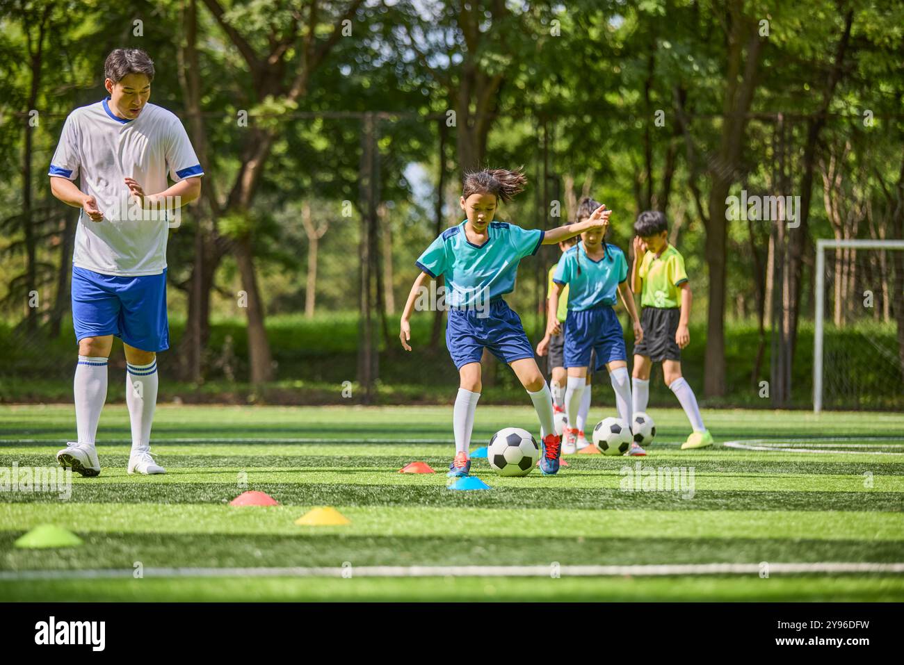 Coach and Kids in Football Training Class Stock Photo - Alamy