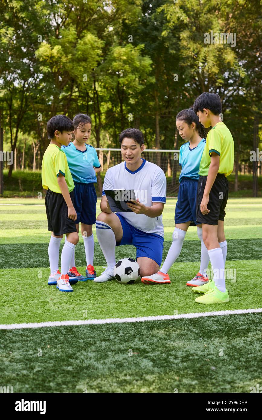 Coach and Kids in Football Training Class Stock Photo - Alamy