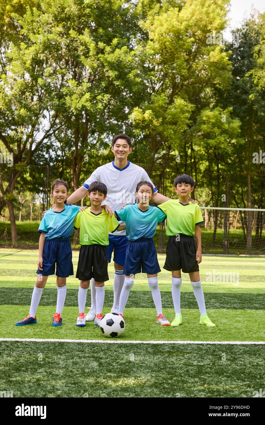 Coach and Kids in Football Training Class Stock Photo - Alamy