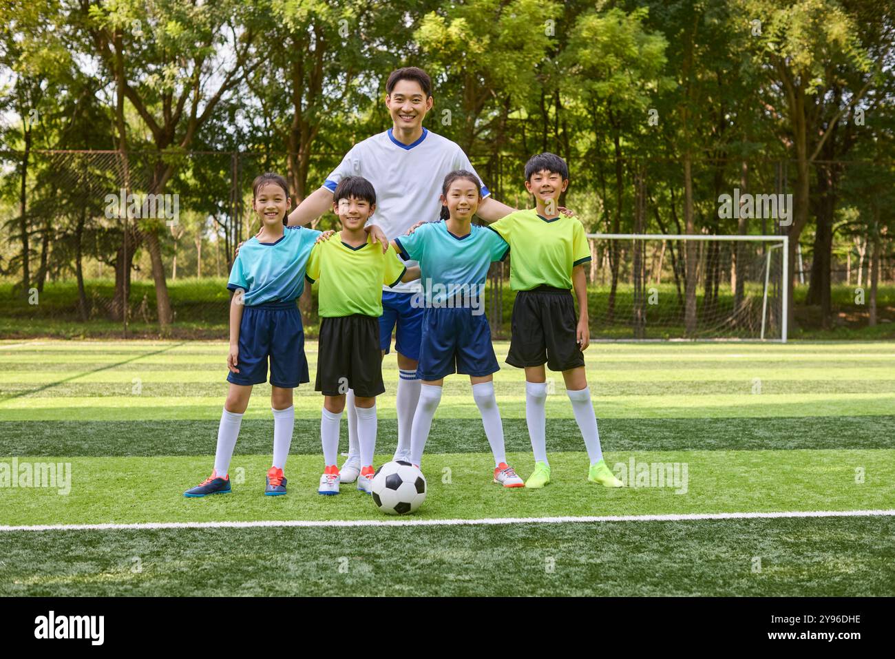 Coach and Kids in Football Training Class Stock Photo - Alamy