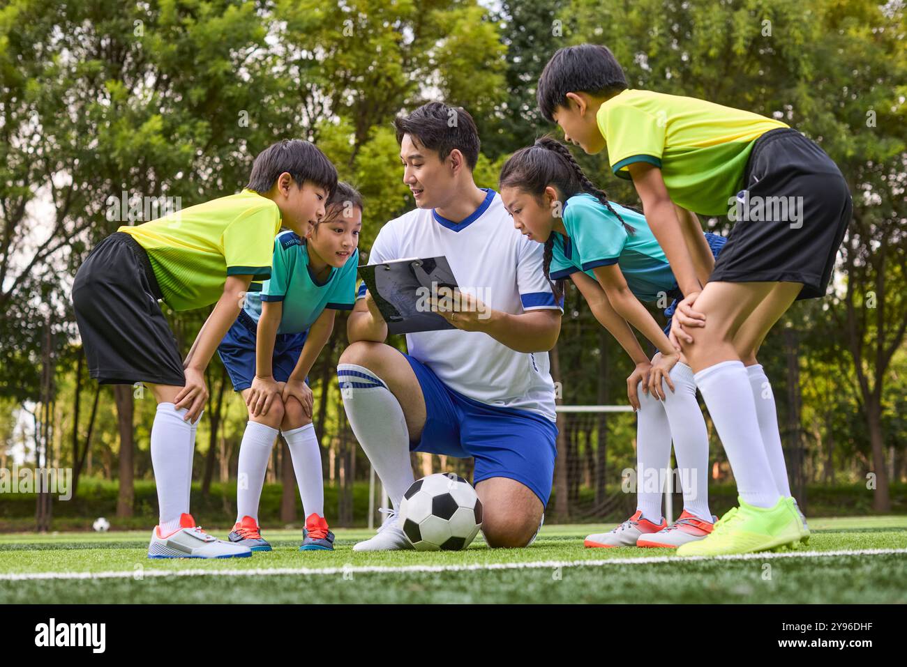 Coach and Kids in Football Training Class Stock Photo - Alamy