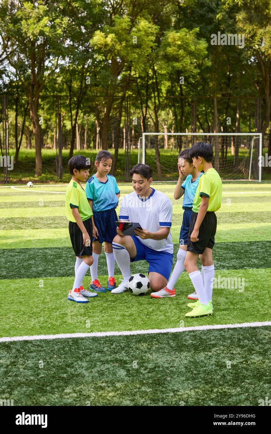 Coach and Kids in Football Training Class Stock Photo - Alamy