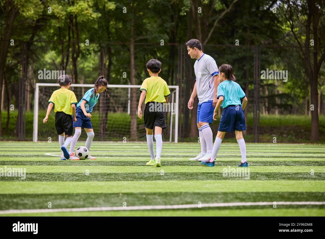 Kids Playing Football on Soccer Field Stock Photo - Alamy