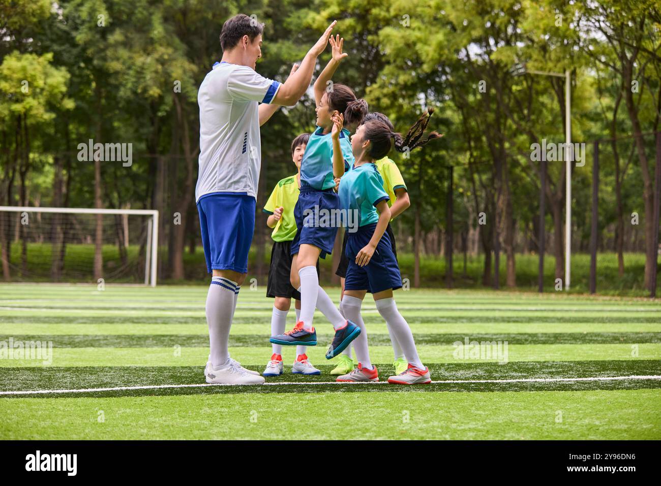 Coach and Kids in Football Training Class Stock Photo - Alamy
