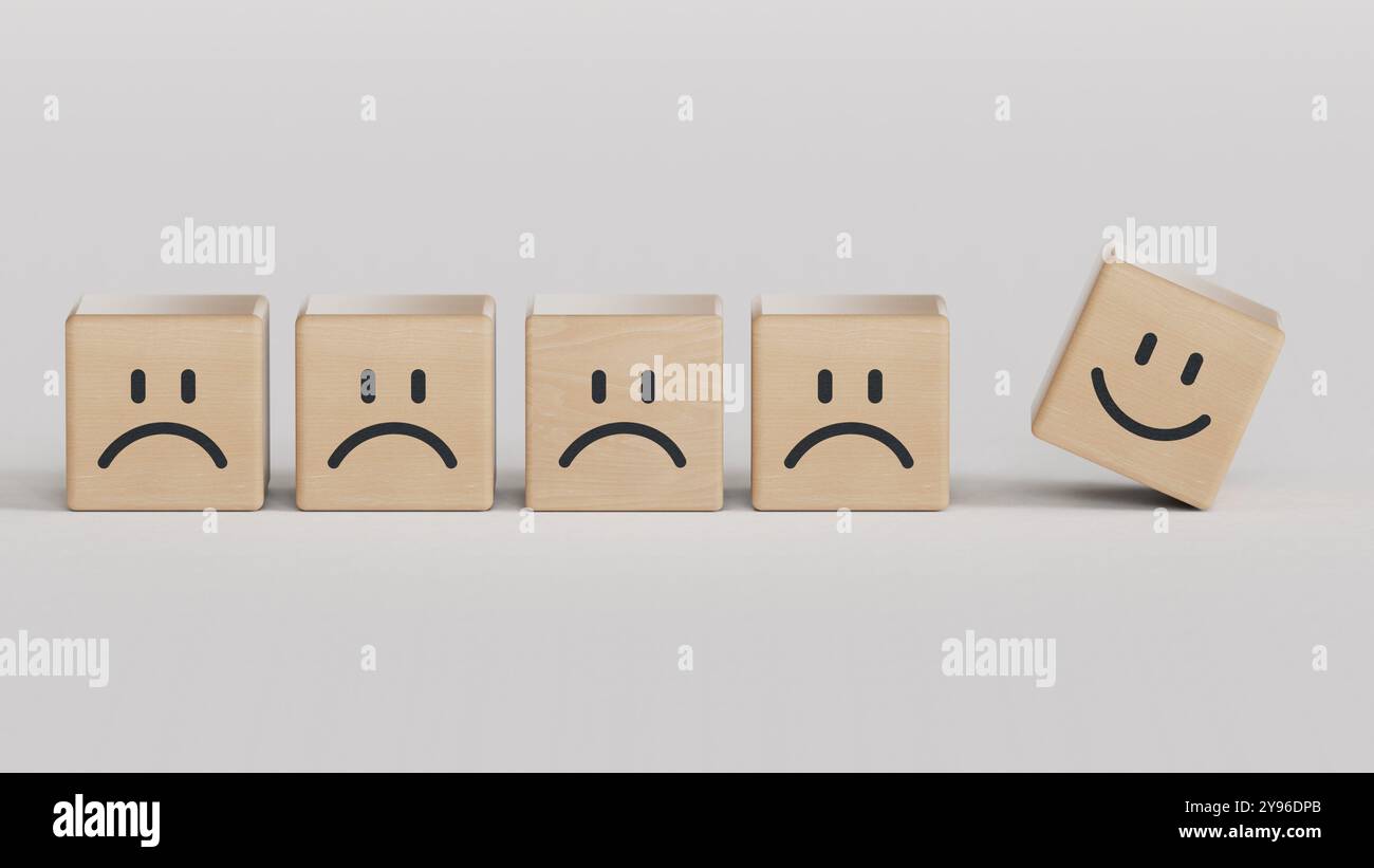 Hand holding smile face which print screen on wooden cube block among ...