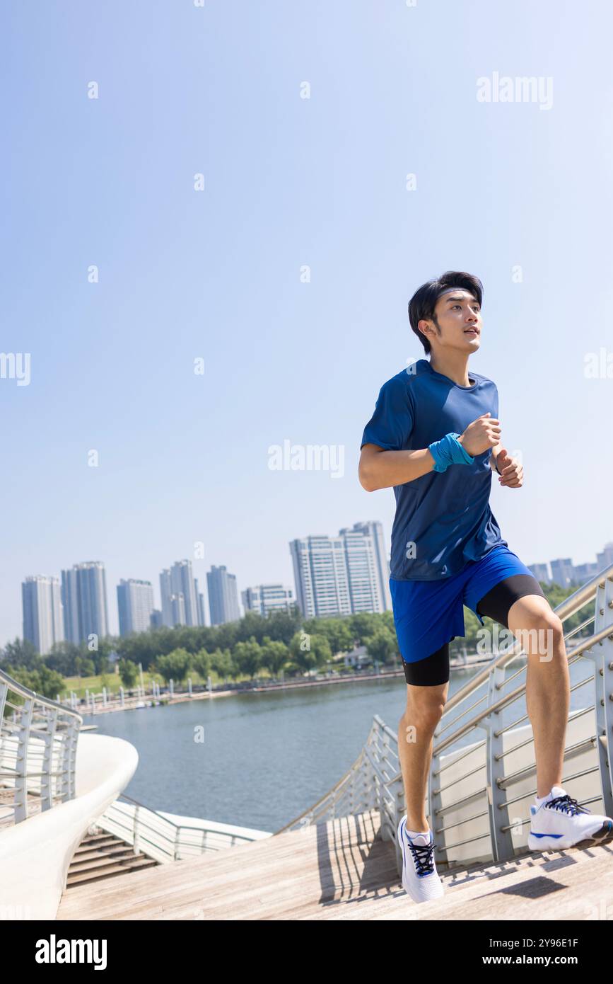 Young Chinese man jogging in a park Stock Photo - Alamy