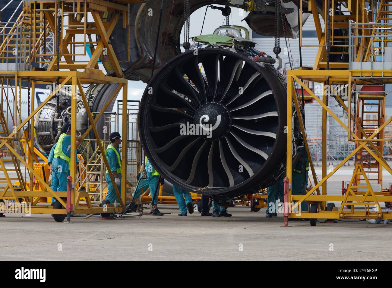 Engineers repairing an Airbus A350 passenger jet engine after reported ...
