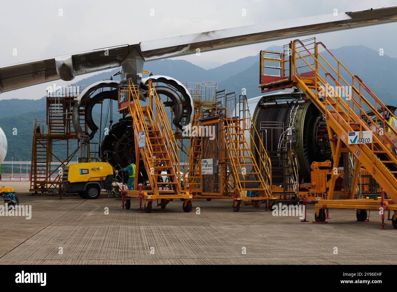 Engineers repairing an Airbus A350 passenger jet engine after reported ...