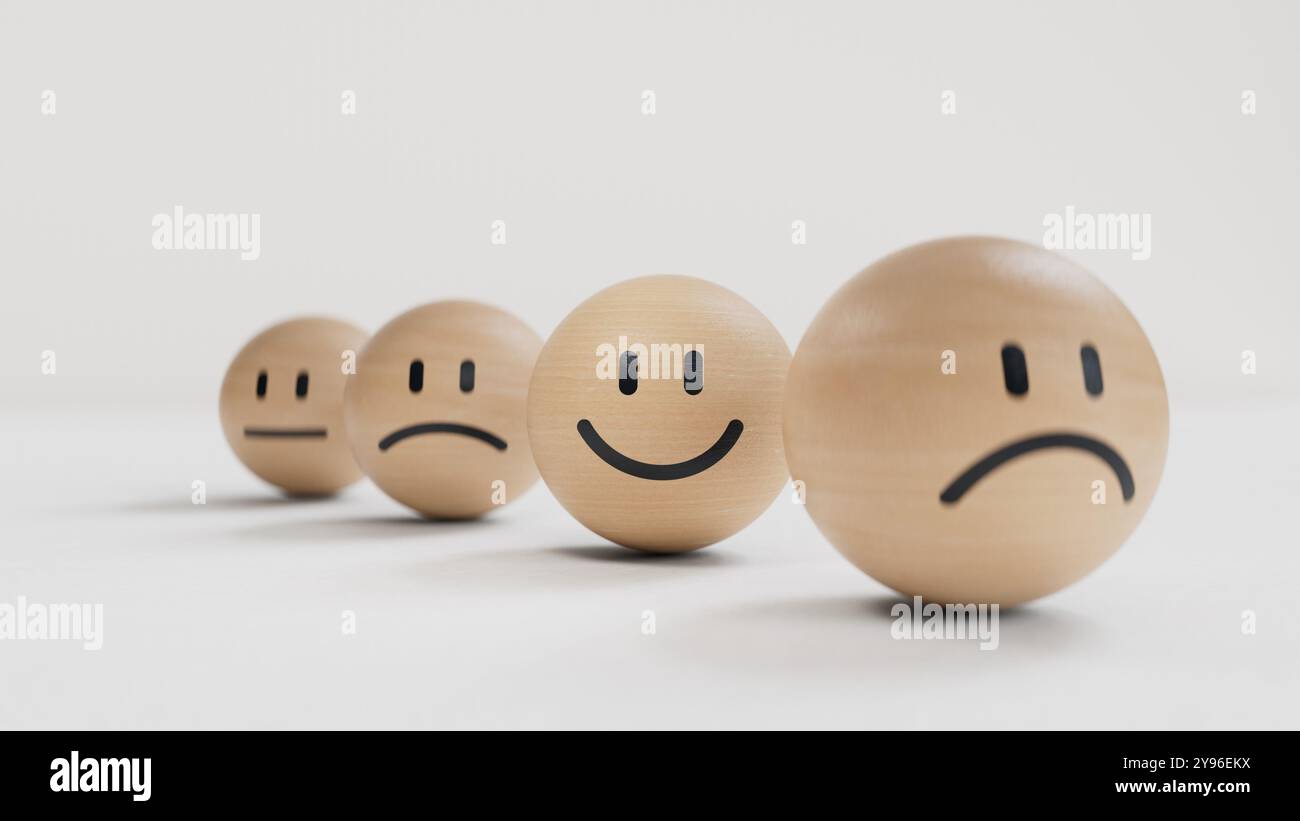 Small balls showing different types of emotions.Wood cube with smile ...