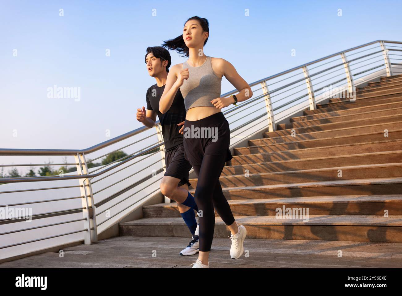 Young couple running on the steps Stock Photo - Alamy