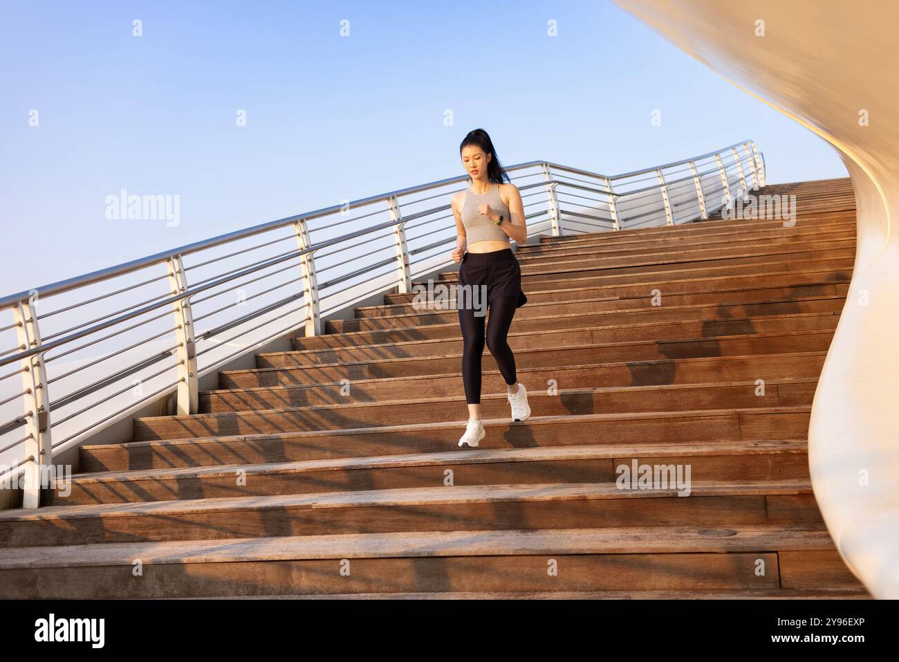 Young Chinese woman running on the steps Stock Photo - Alamy
