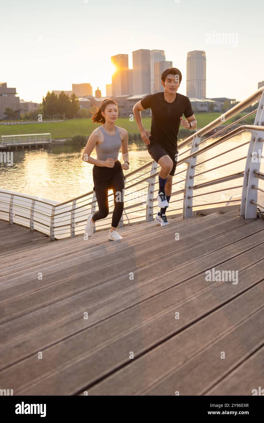 Young couple running on the steps Stock Photo - Alamy