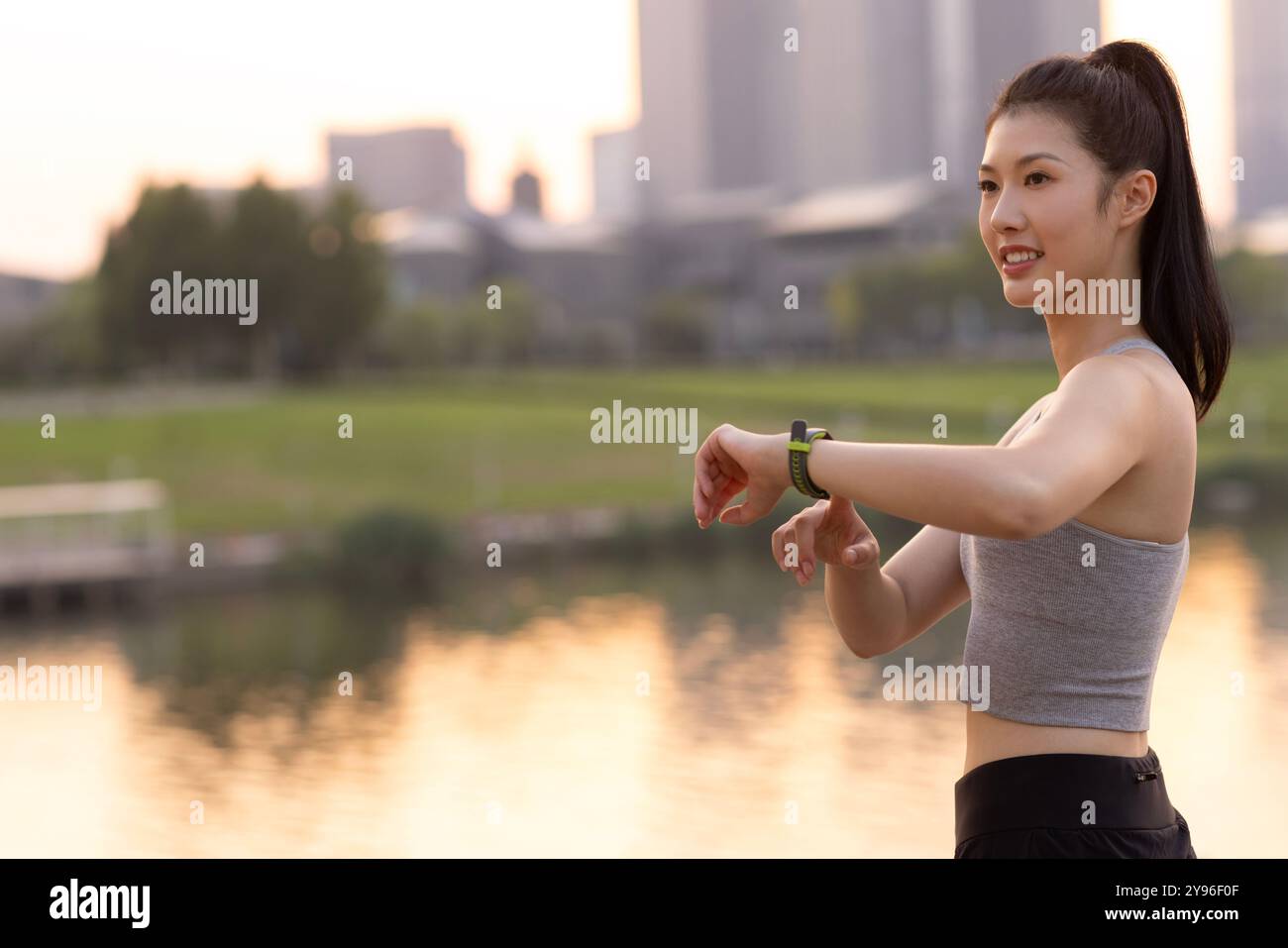 Young woman check her smart watch Stock Photo - Alamy
